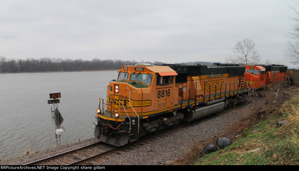 BNSF 8816 Brings up a empty coal next to the Mississippi river.